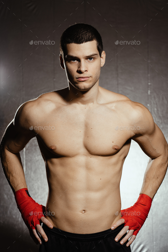 Athletic boxer getting ready before the fight over black background ...