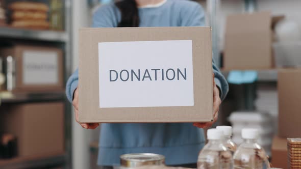 Close Up Female Hands Holding Donation Box by clickmymedia | VideoHive