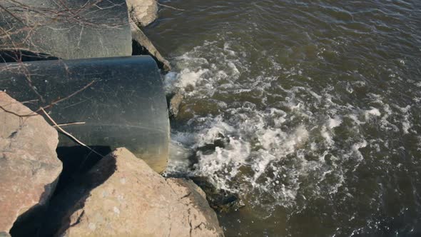 Close view of water flowing out of large sewage pipes into lake, Stock ...