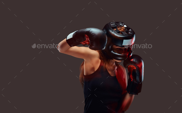 Beautiful brunette female boxer in sportswear. Isolated on dark ...