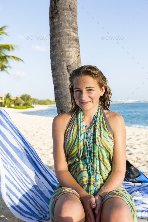 smiling 13 year old girl sitting in beach chair, Grand Cayman Island ...