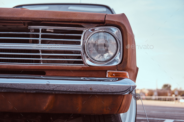 Cropped front view of a restored retro car. Stock Photo by fxquadro