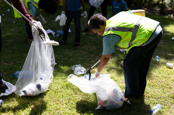 Multi-generation mixed race family collecting garbage Stock Photo by ...