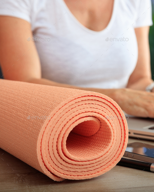 Woman and an exercise mat in an office background Stock Photo by rawf8