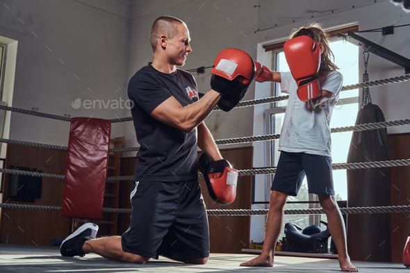 Little cute girl got her's first boxing training Stock Photo by fxquadro