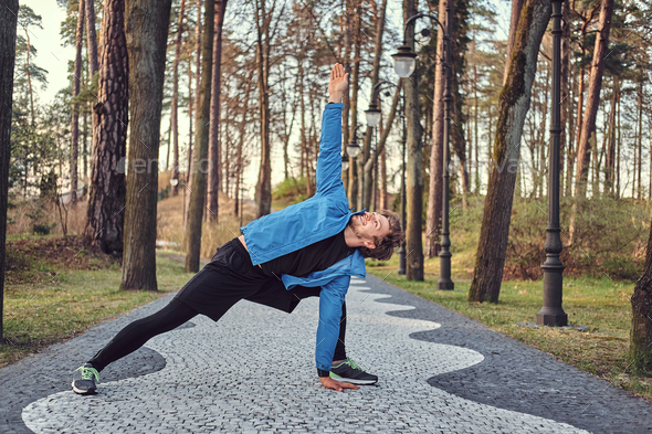 Sportive man is doing exercises outside Stock Photo by fxquadro | PhotoDune