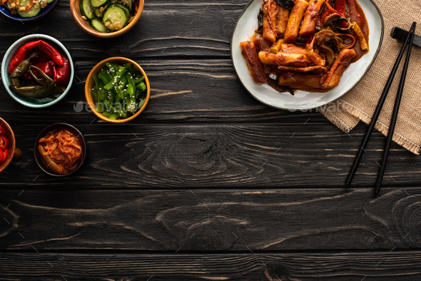 top view of spicy topokki near korean braised potatoes Stock Photo by ...