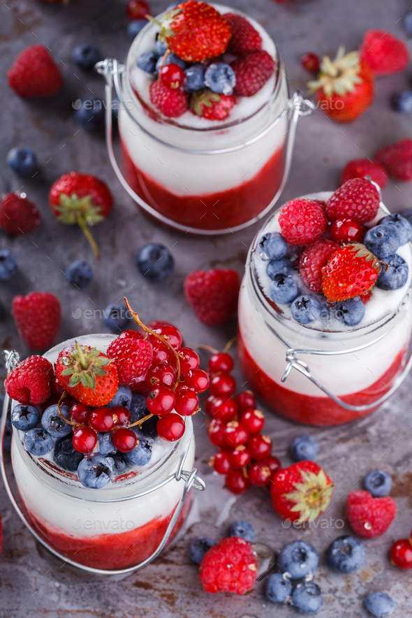Yogurt,homemade,with fresh berries, berry puree in a glass container ...