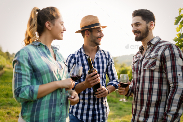 People sampling and tasting wines in vineyard Stock Photo by nd3000