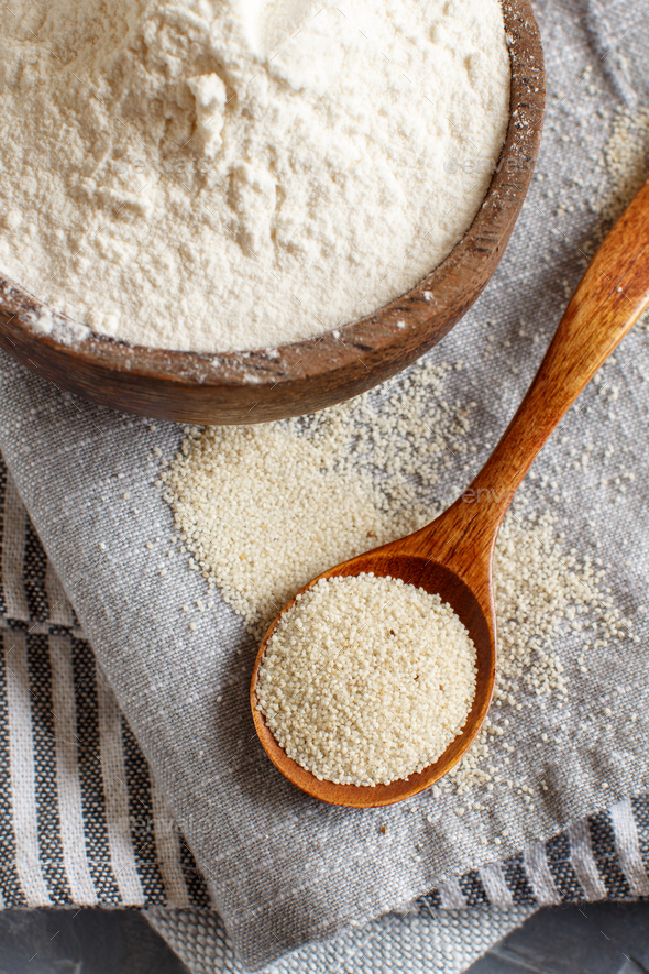 Raw fonio flour and seeds with a spoon on grey napkins Stock Photo by ...