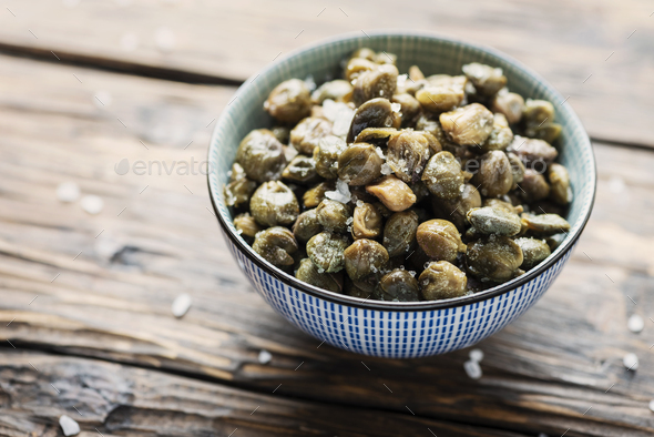 Salt capers on the wooden table Stock Photo by OxanaDenezhkina | PhotoDune