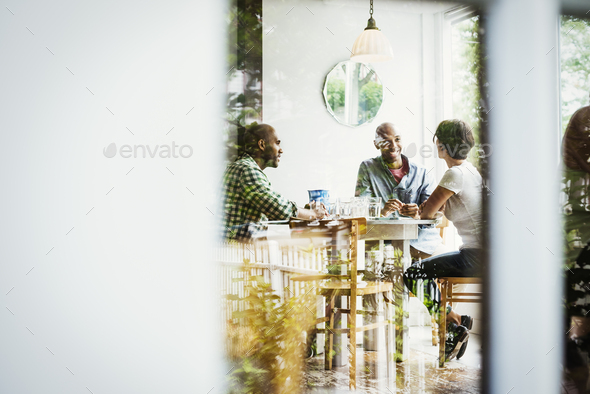 View through a window into a cafe, people sitting at tables. Stock ...