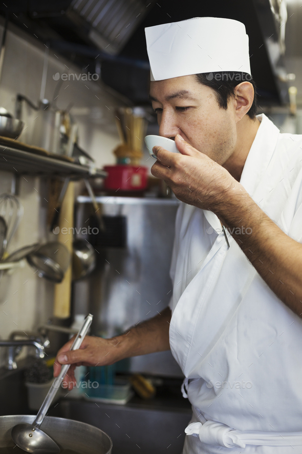 Chef working in the kitchen of a Japanese sushi restaurant, tasting ...