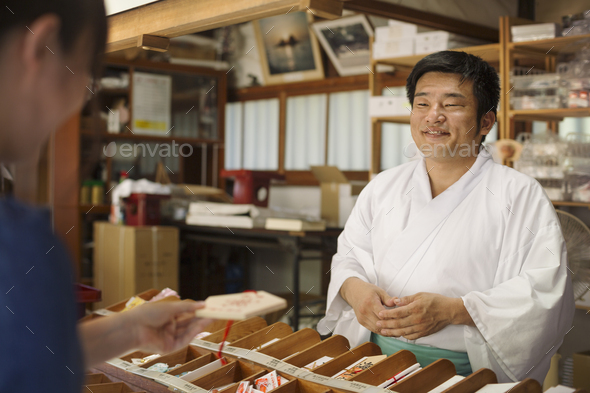 Salesman wearing white kimono at Shinto Sakurai Shrine, Fukuoka, Japan ...