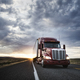3/4 front view of a commercial truck on the road at sunset in eastern ...