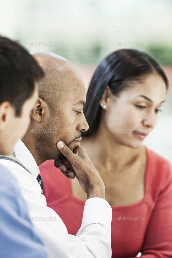 Mixed race team of business people at a table in a business center ...