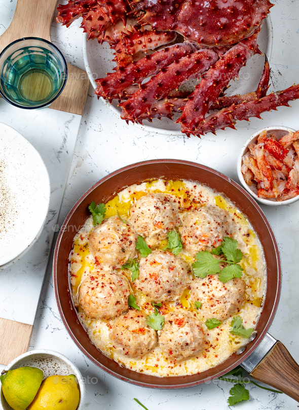 CRABMEATBALLS crab meatballs in white creamy sauce in red pan Stock ...