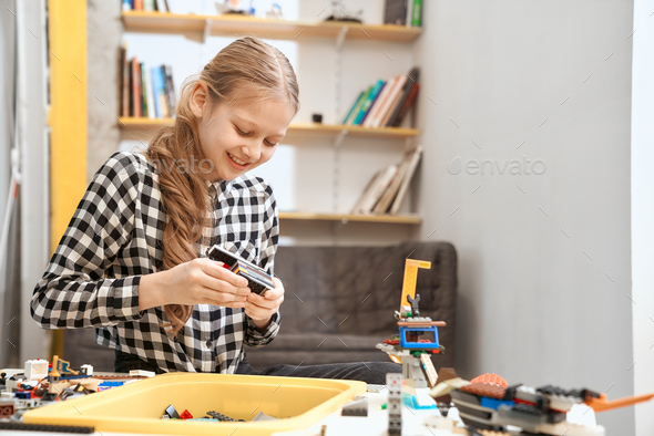 Caucasian girl using building kit Stock Photo by serhiibobyk | PhotoDune