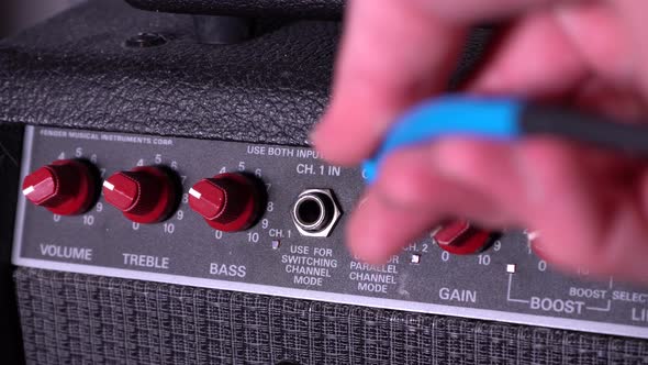 Plugging cable into Channel 2 of an amplifier., Stock Footage | VideoHive