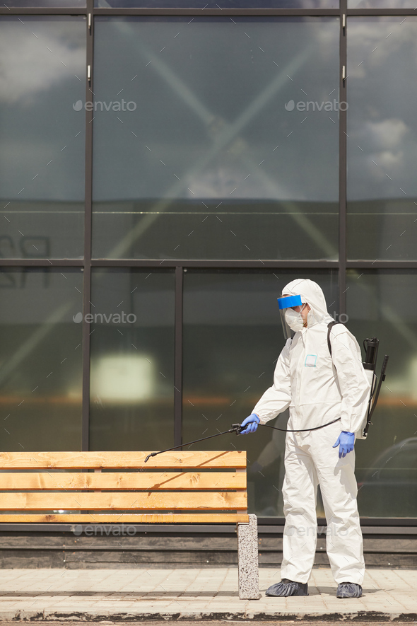 Worker Disinfecting Bench Background Stock Photo by seventyfourimages