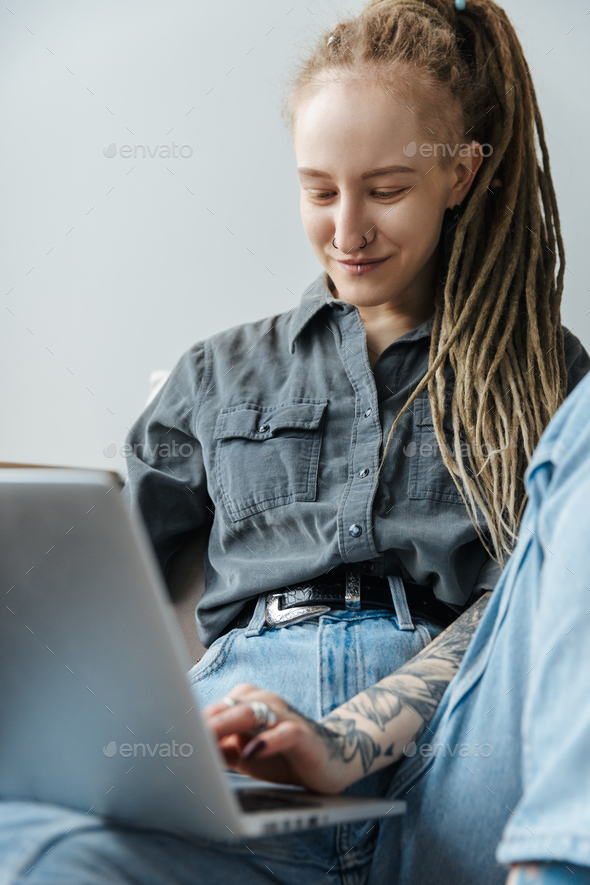 Optimistic young girl using laptop computer. Stock Photo by vadymvdrobot