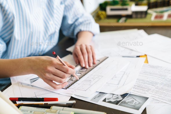 Cropped photo of woman architect making drawing while designing draft ...