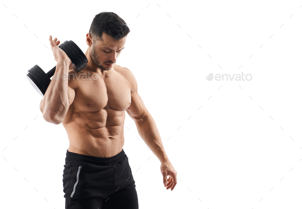 Shirtless bodybuilder holding dumbbell on shoulder Stock Photo by ...