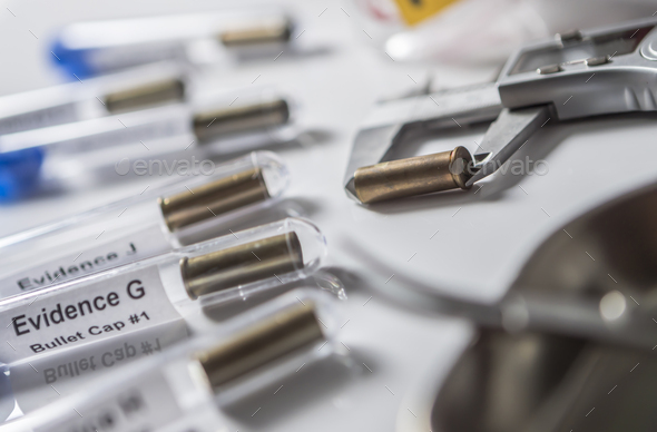 Expert Police measures bullet caliber in ballistic lab, conceptual ...