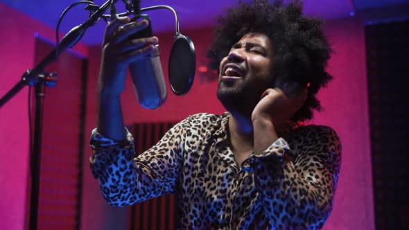 Young professional afro singer recording a new song album inside music ...