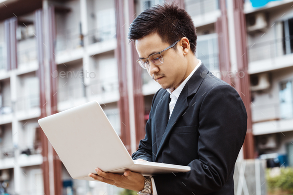 Concept Business - Handsome asian Business man working on property ...