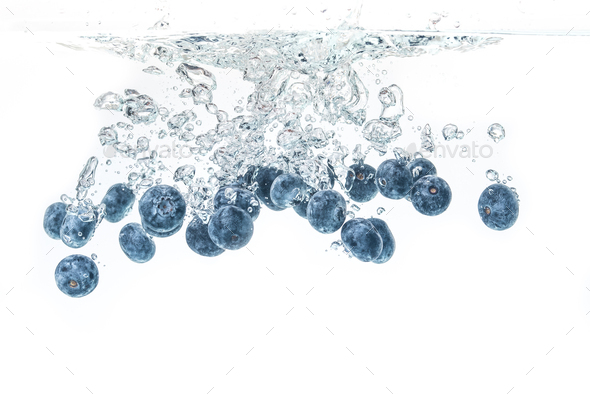 Blueberry’s splashing into crystal clear water with air bubbles Stock ...