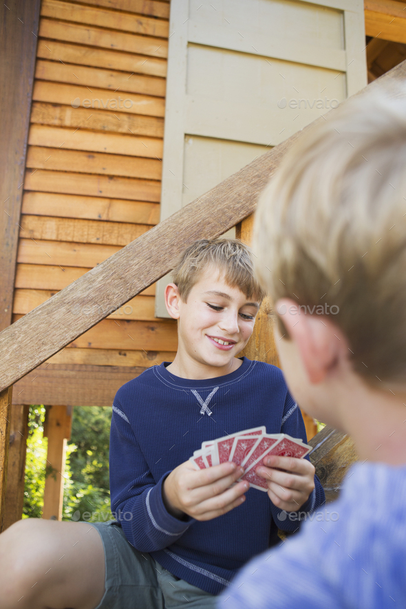 Two brothers playing cards. Stock Photo by Mint_Images | PhotoDune