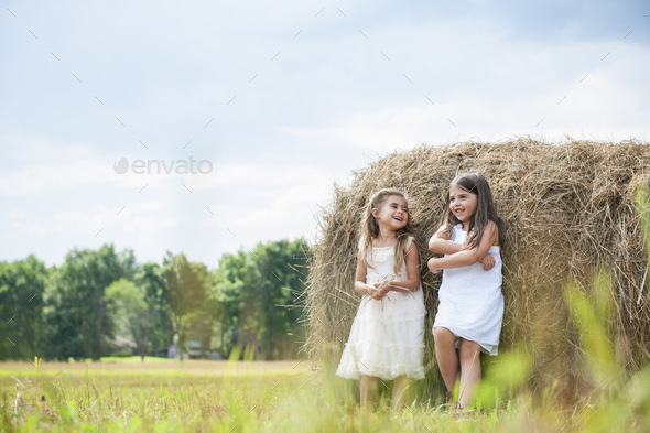 Two girls playing outdoors. Stock Photo by Mint_Images | PhotoDune