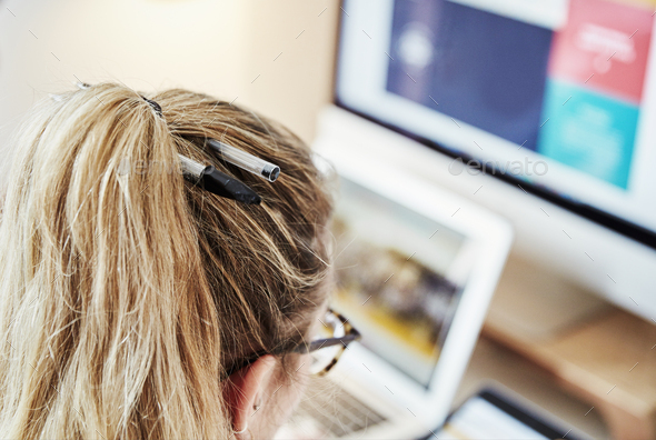 Over the shoulder view, woman at a workstation Stock Photo by Mint_Images