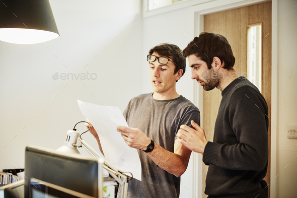 two people discussing a design plan Stock Photo by Mint_Images | PhotoDune