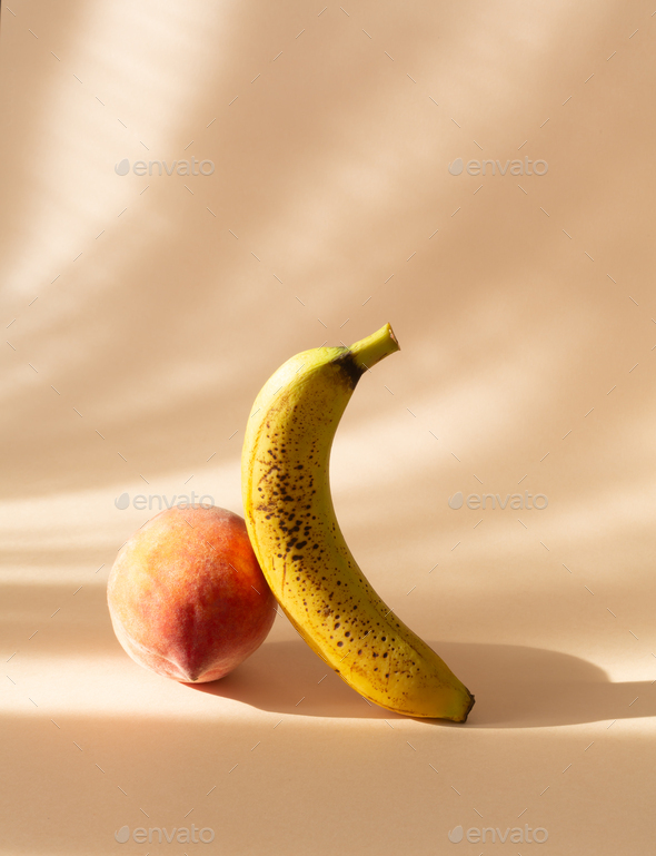 Fresh peach and ugly banana on a pastel background with shadows Stock ...