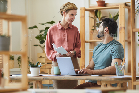 Two Colleagues in Green Office Space Stock Photo by seventyfourimages