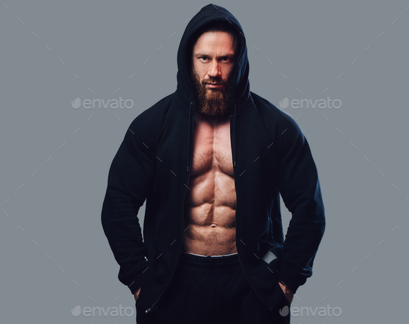 Bodybuilder in a black jacket with a hood. Stock Photo by fxquadro
