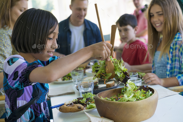 A family party around a table in a cafe. Adults and children. Stock ...