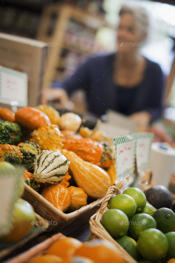 An organic farm stand,with a display of gourds and squash of different ...