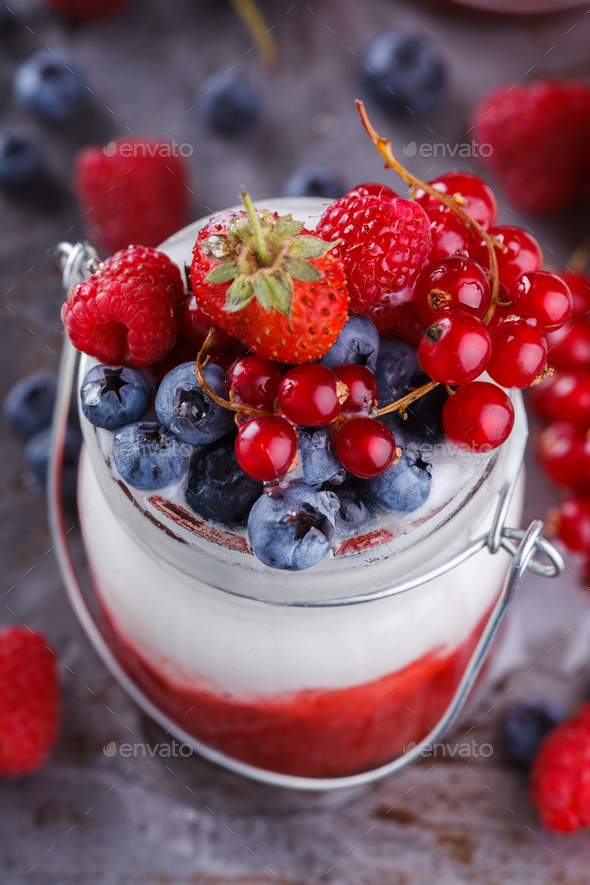 Yogurt,homemade,with fresh berries, berry puree in a glass container ...