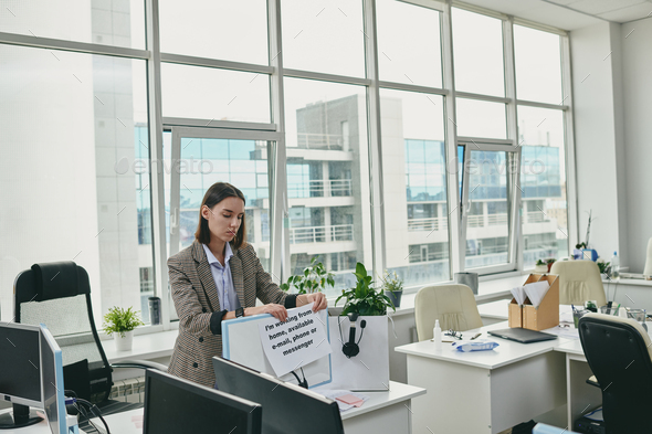 Young elegant secretary putting paper with note about her working from ...