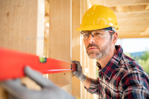 Worker with work tools working on structure of construction at building ...