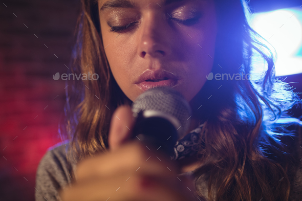 Beautiful female singer performing at concert Stock Photo by Wavebreakmedia