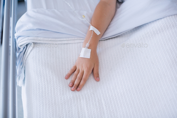 Boy patient hand injected with saline iv drip Stock Photo by Wavebreakmedia