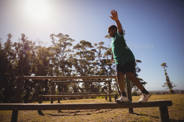 Boy walking on obstacle during obstacle course Stock Photo by ...