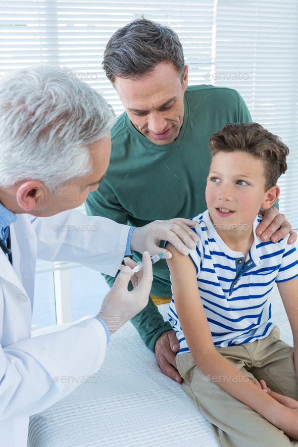 Doctor giving an injection to the patient Stock Photo by Wavebreakmedia