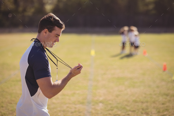 Coach holding stopwatch in park Stock Photo by Wavebreakmedia | PhotoDune