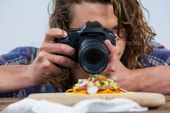 Photographer clicking a picture of food using digital camera Stock ...
