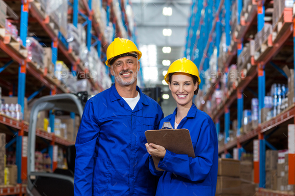 Warehouse workers standing together in warehouse Stock Photo by ...